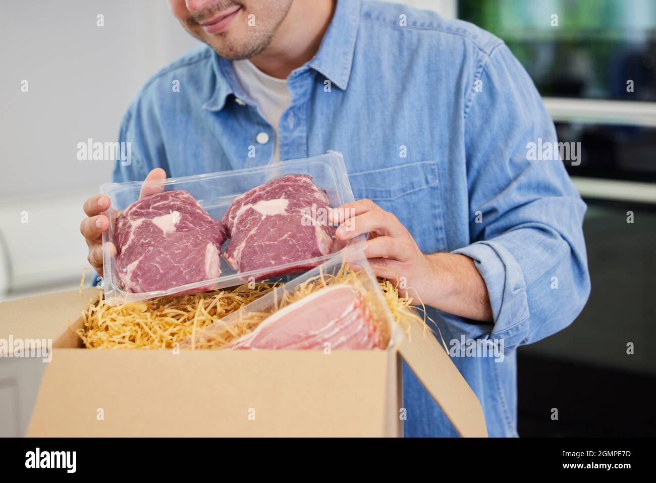 Man Unpacking Online Luxury Meat Order Of Steak And Bacon Delivered To ...