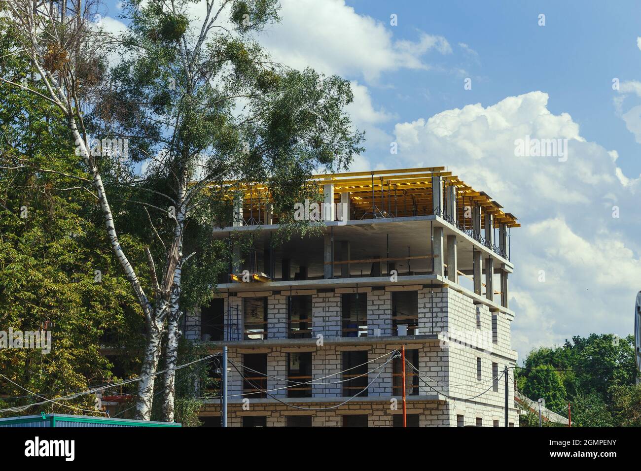 View of a low-rise monolithic building under construction with walls ...