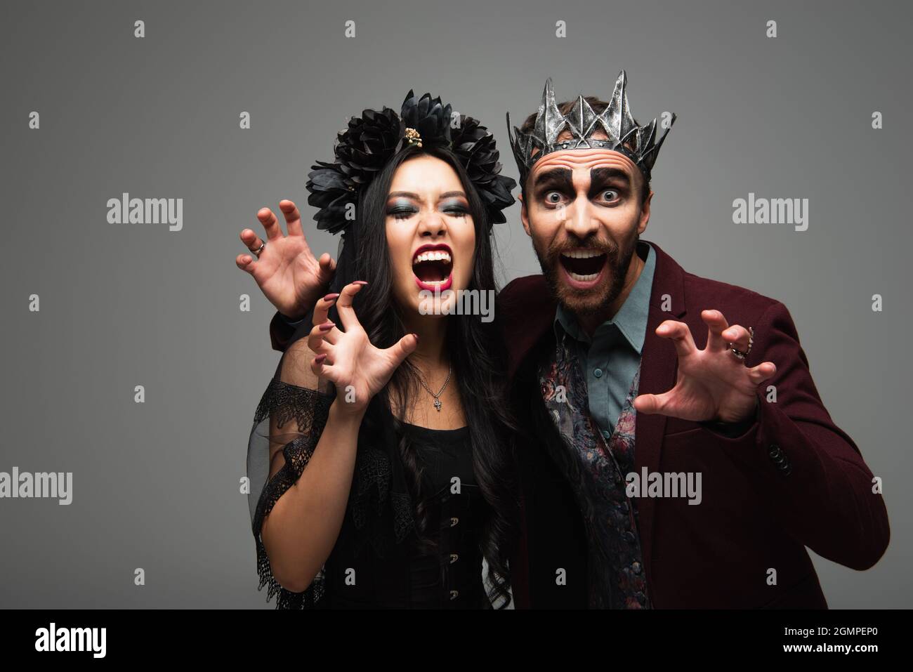 interracial couple in vampires halloween costumes growling and showing ...