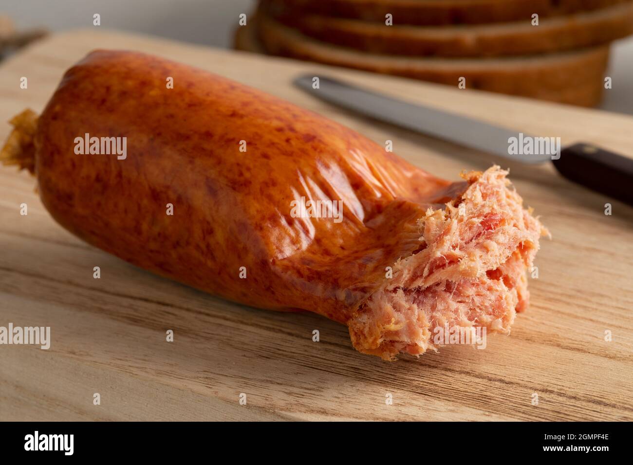 Single traditional German grob Teewurst, coarsely ground sausage, open ...