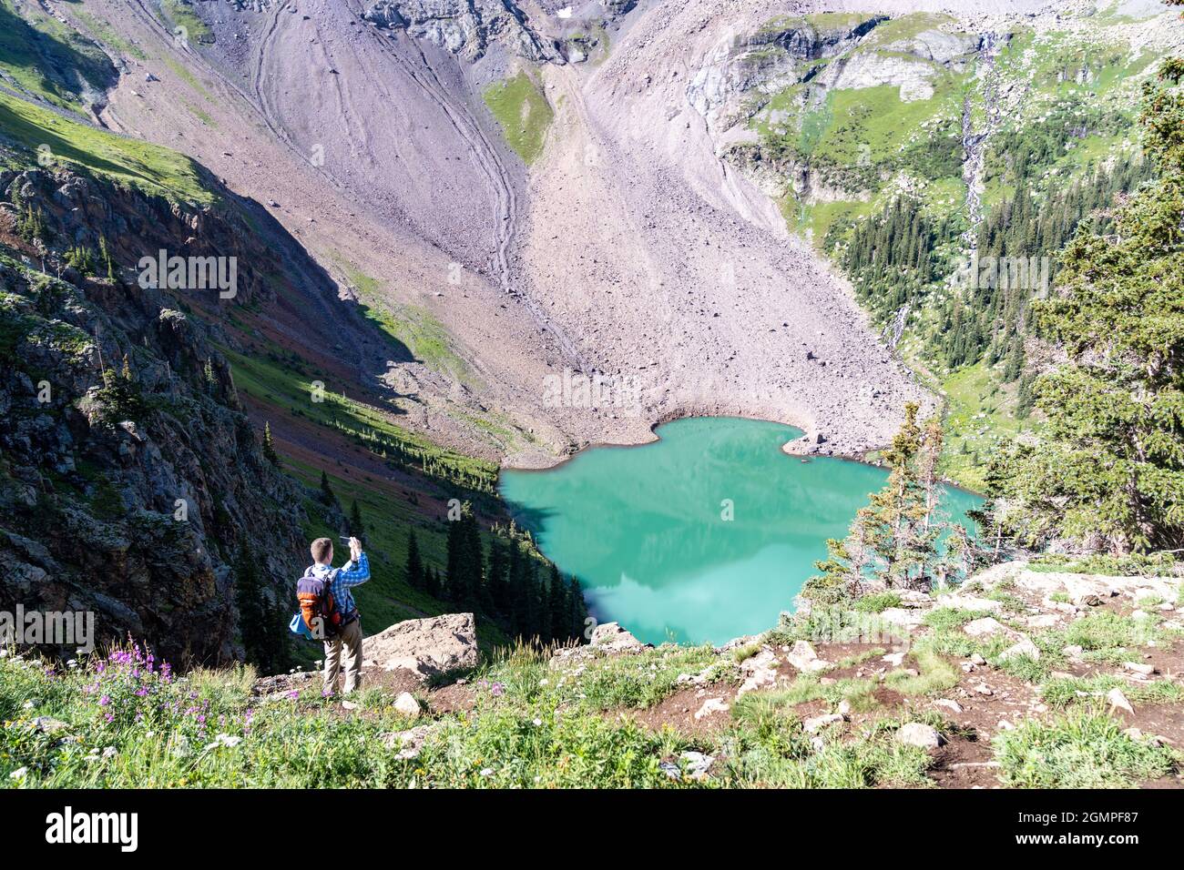 Colorado, USA - August 4, 2021: Adult male hiker takes photos above ...