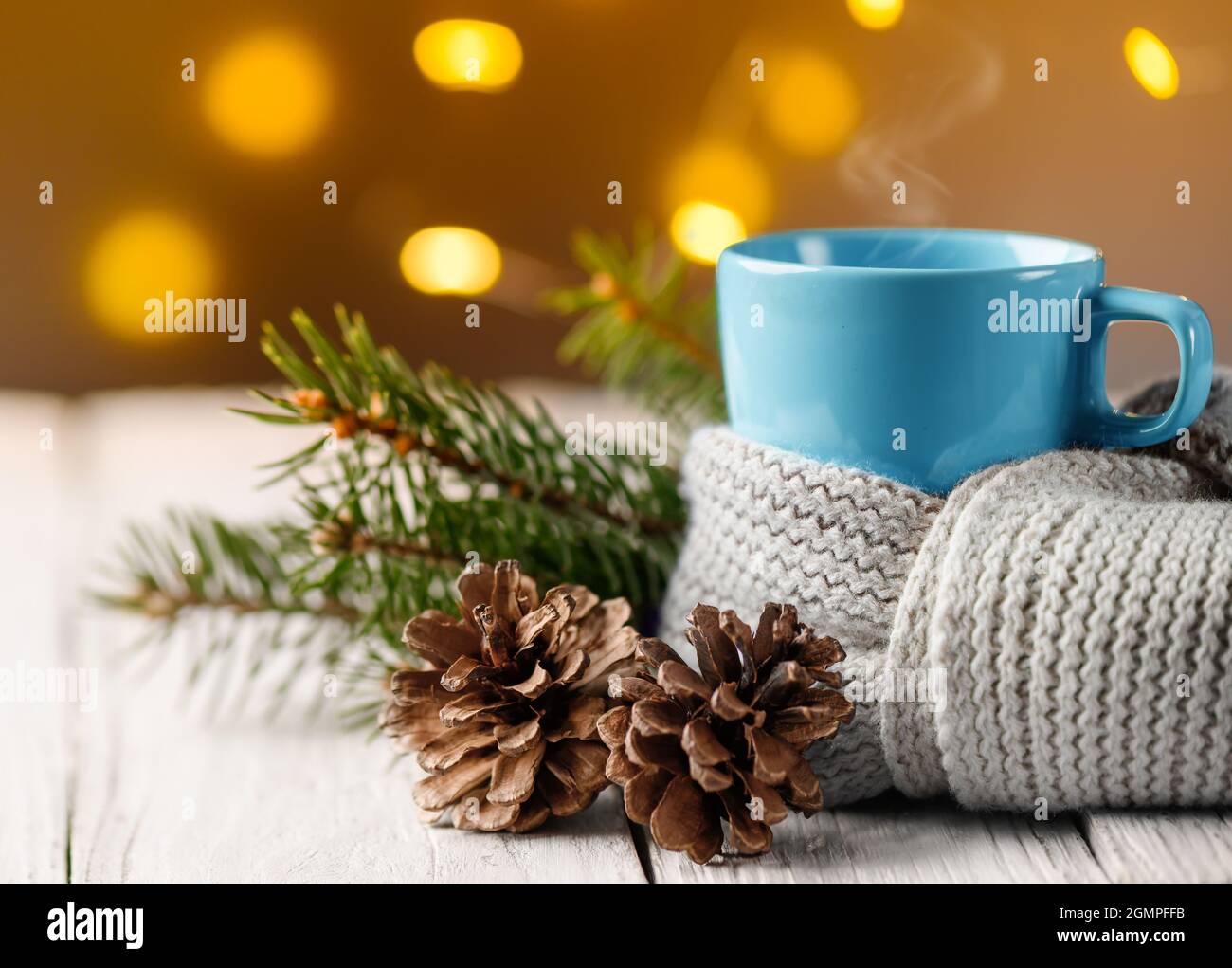 Cup of tea covered with warm scarf with pine cone and fir branch Stock ...