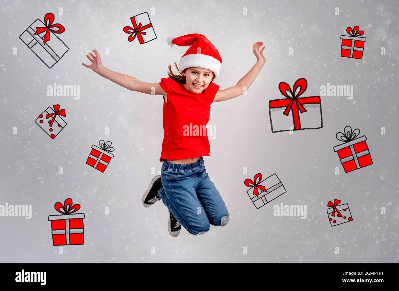 Little girl jumping between christmas presents Stock Photo - Alamy