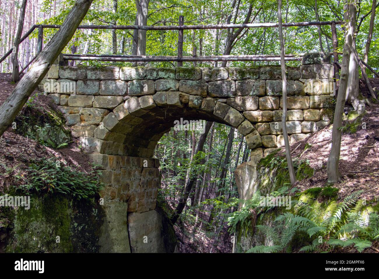 Old stone bridge over a rocky gap in the forest Stock Photo - Alamy