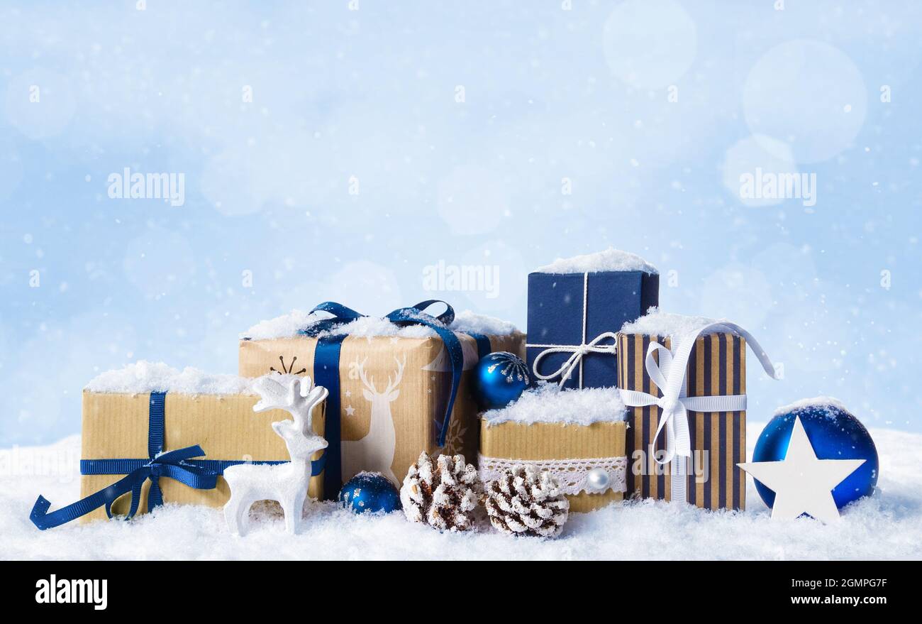 Christmas present boxes in snow Stock Photo - Alamy