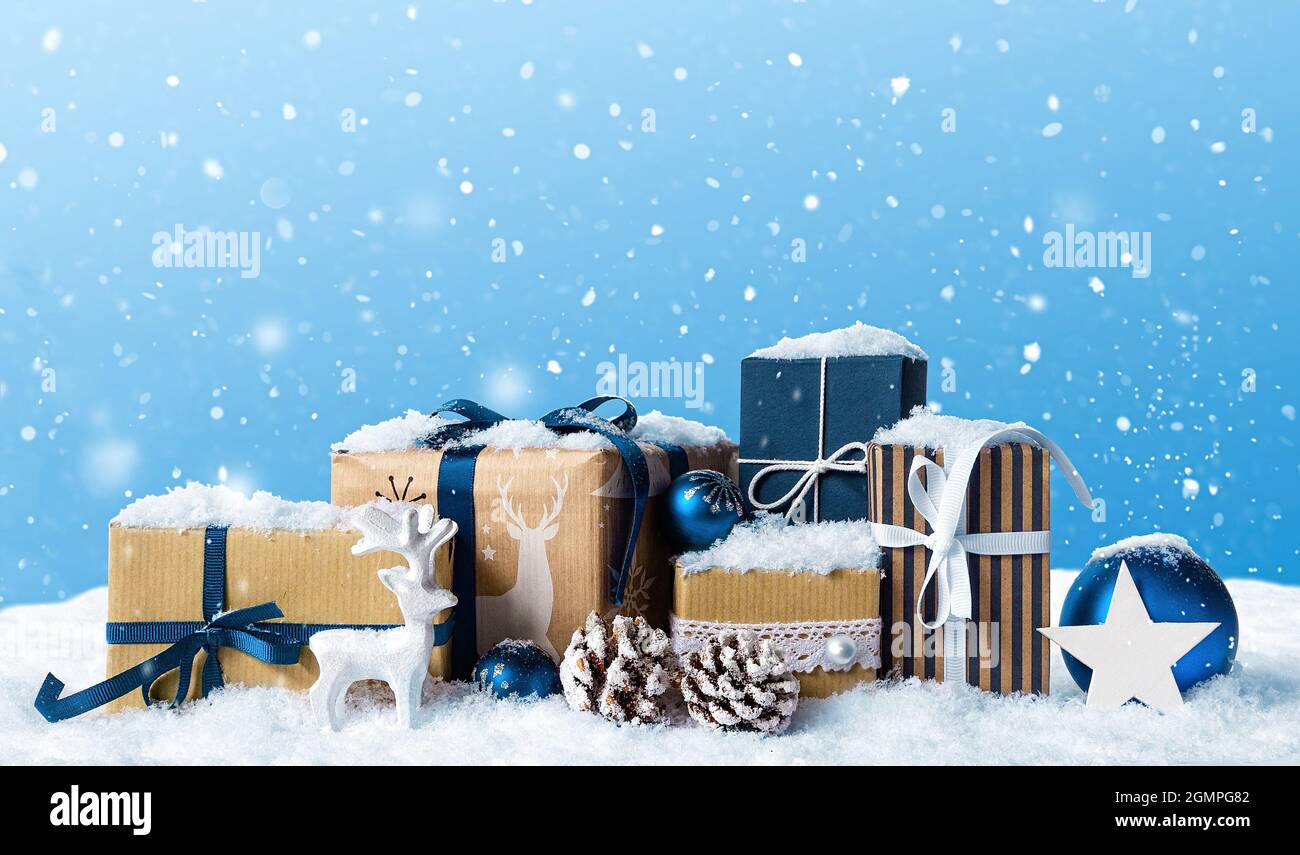Christmas gift boxes in snow Stock Photo - Alamy