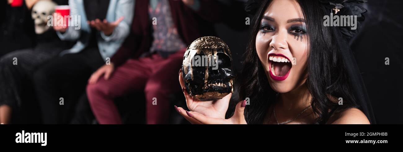 asian woman in vampire halloween makeup showing spooky skull and ...