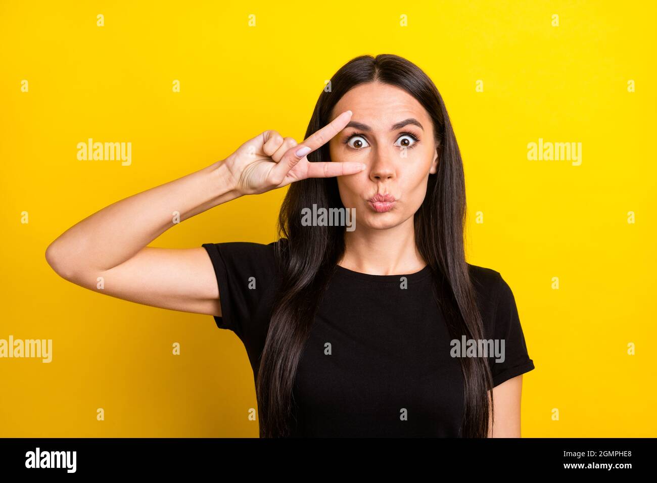 Portrait of adorable person fingers show v-sign near eye kiss lips look ...