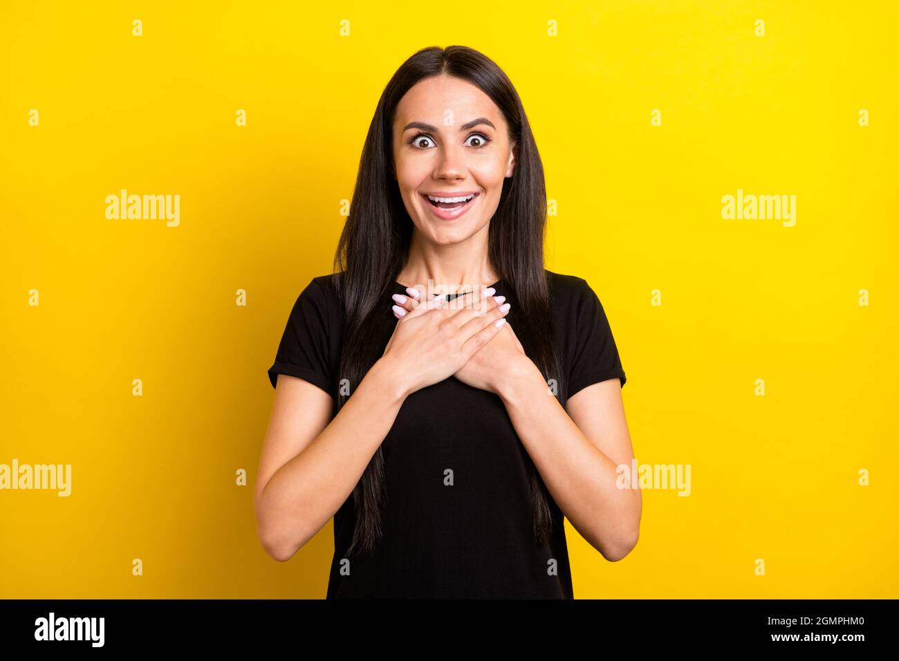 Portrait of impressed positive lady hands palms on chest look camera ...