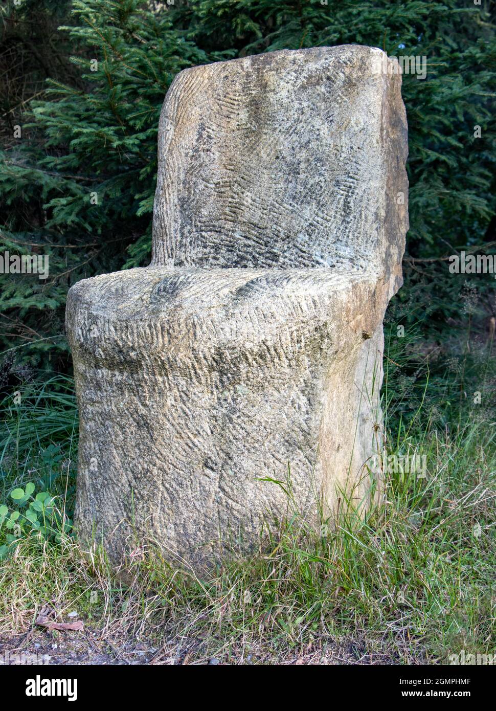 A chair carved from a stone block in nature Stock Photo - Alamy