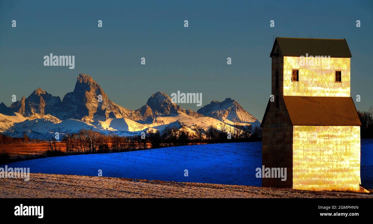 Old abandoned grainary grainery building with snow and Tetons Teton ...