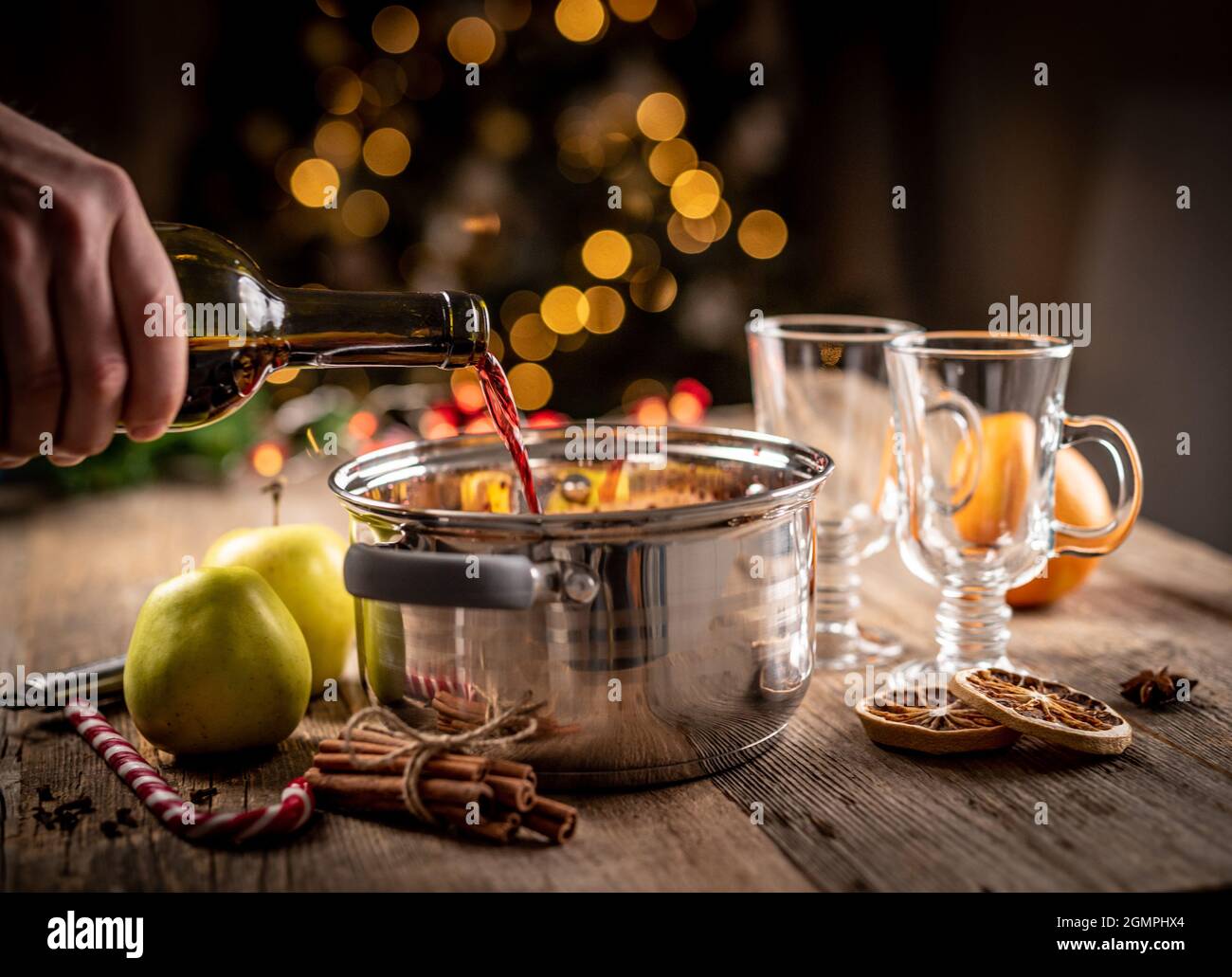 Pouring wine from bottle into pot Stock Photo - Alamy
