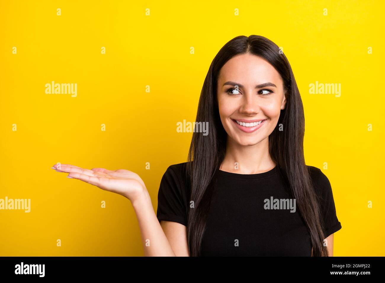 Portrait of charming positive person look interested hand palm hold ...