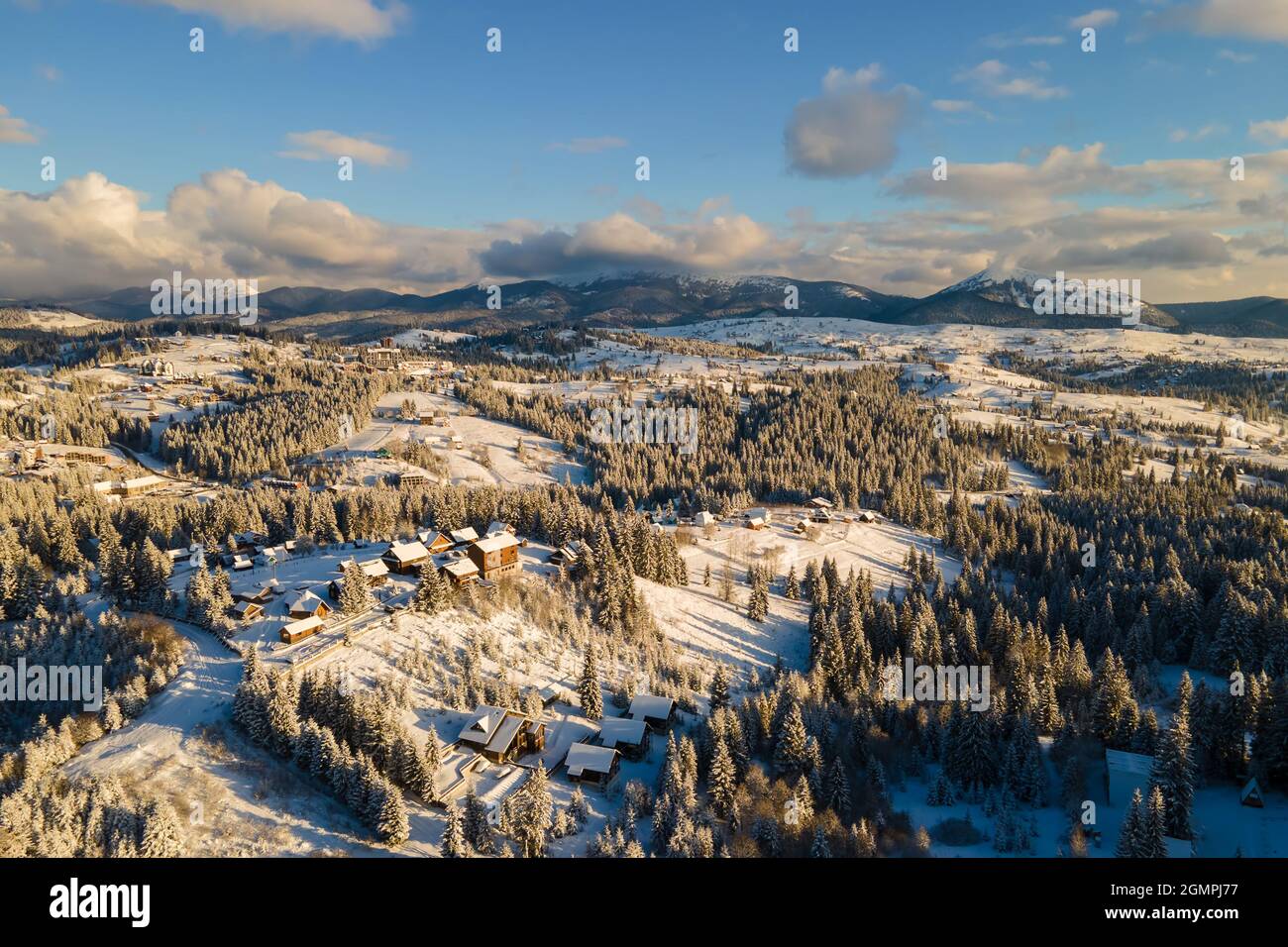 Aerial winter landscape with small village houses between snow covered ...