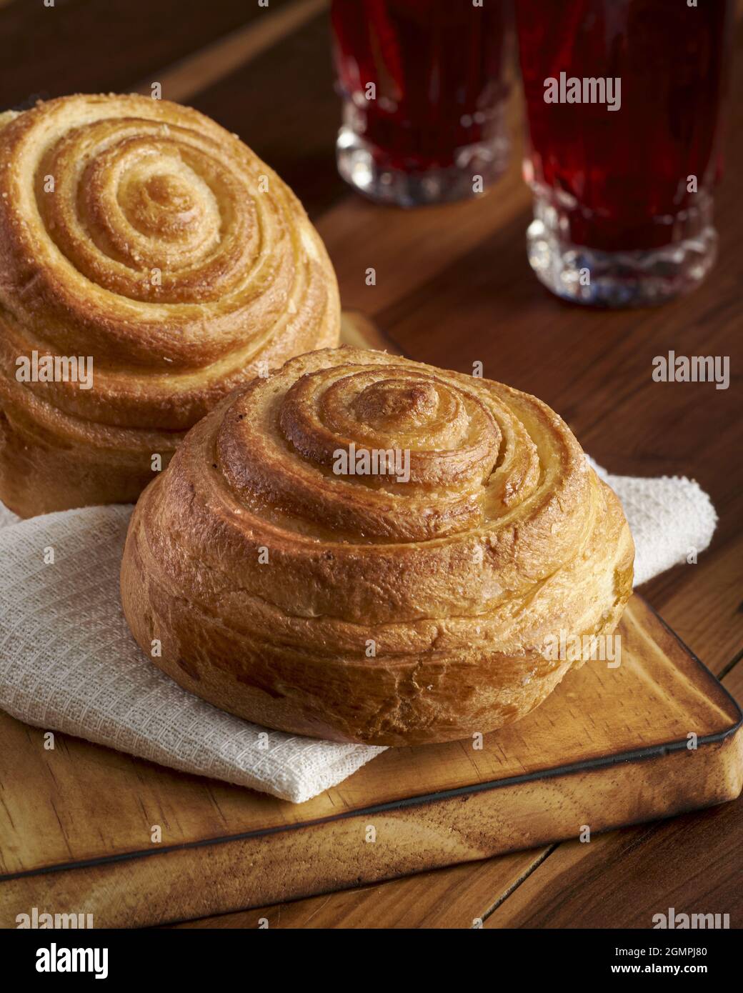 Vertical shot of fresh cinnamon buns on a bo Stock Photo - Alamy
