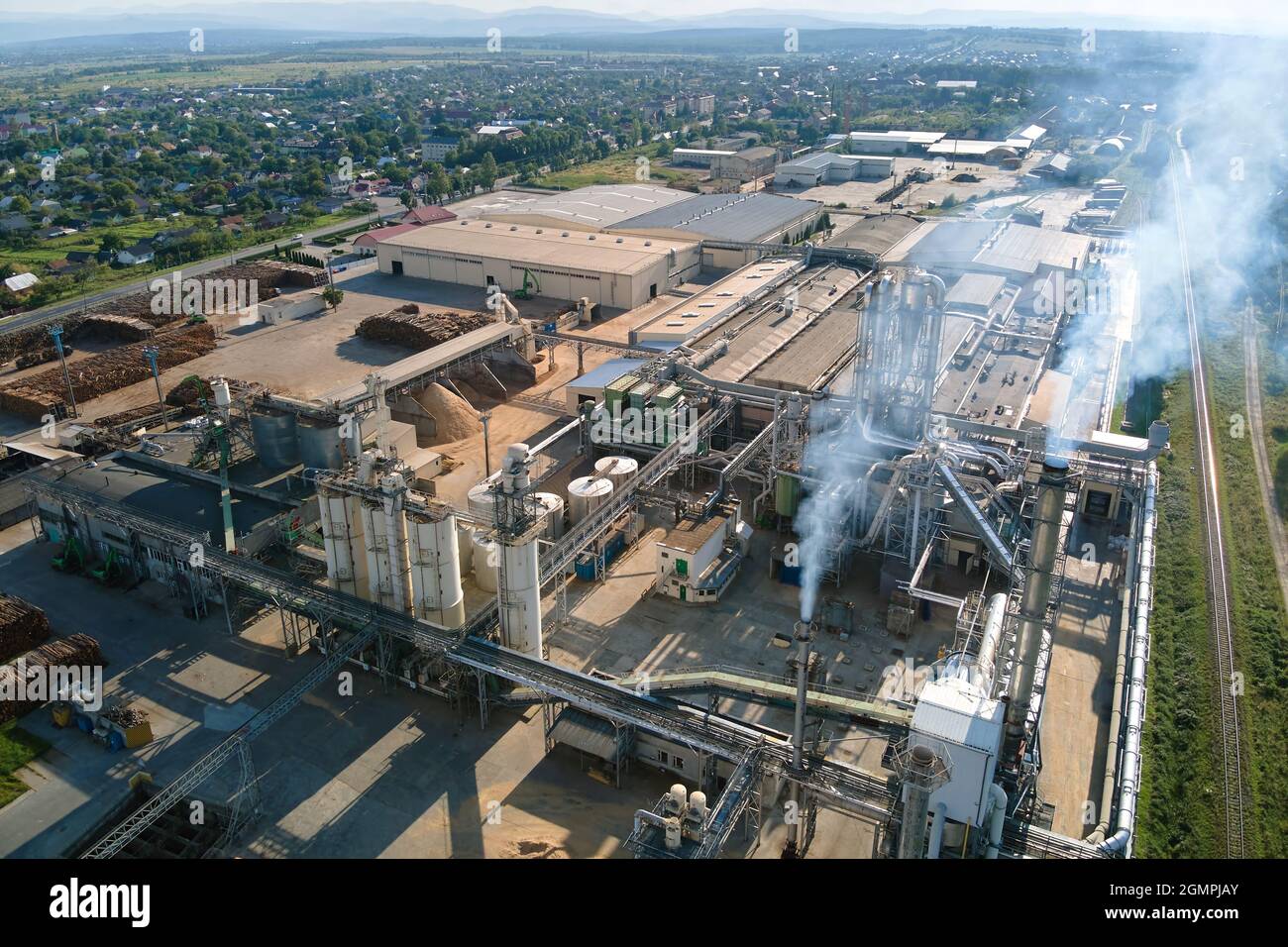 Aerial view of wood processing factory with stacks of lumber at plant ...