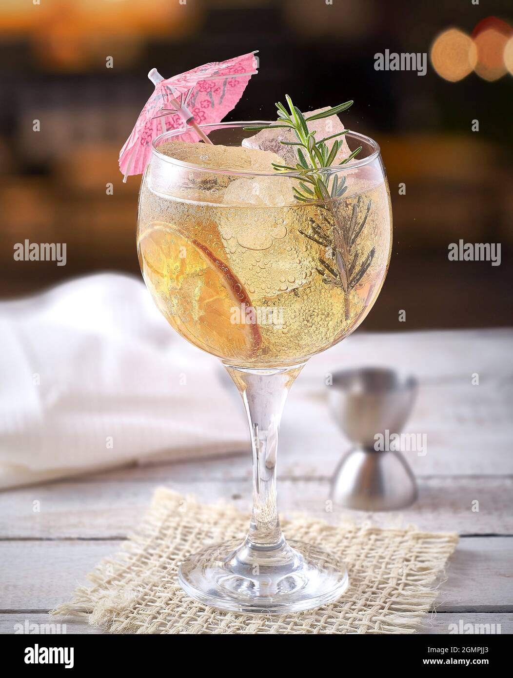 Vertical shot of a glass of iced alcoholic drink with citrus and ...