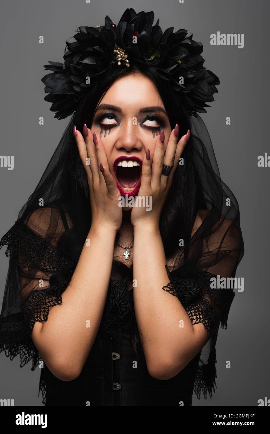 creepy asian woman in vampire halloween costume rolling up eyes and ...