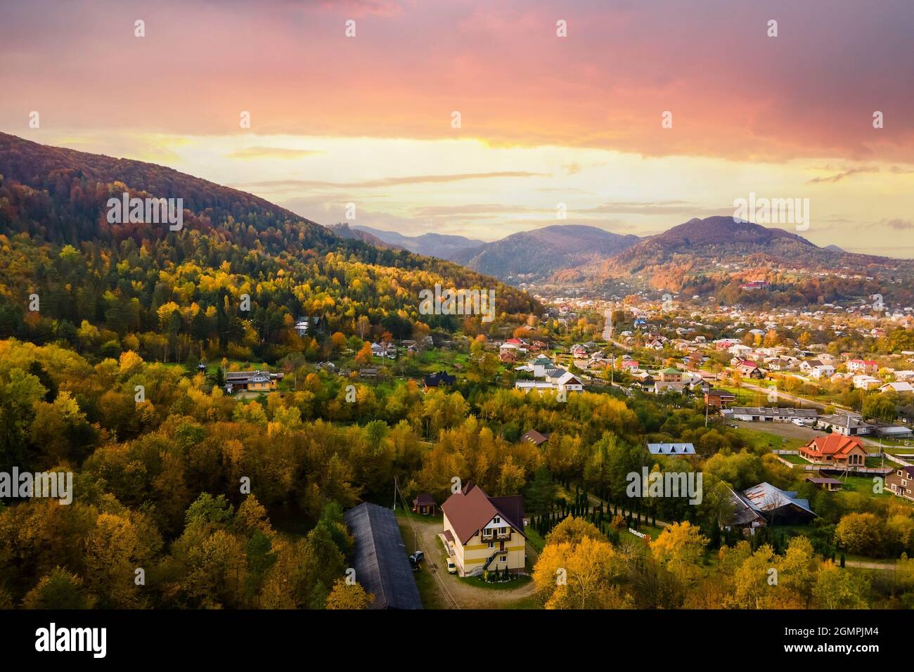Aerial view of a rural village with small houses between autumn ...