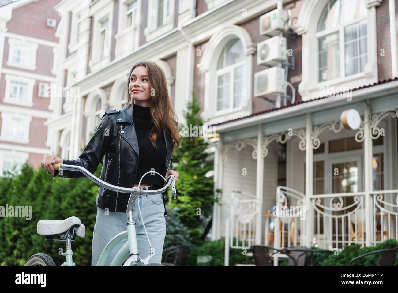 Woman walking her bicycle hi-res stock photography and images - Alamy