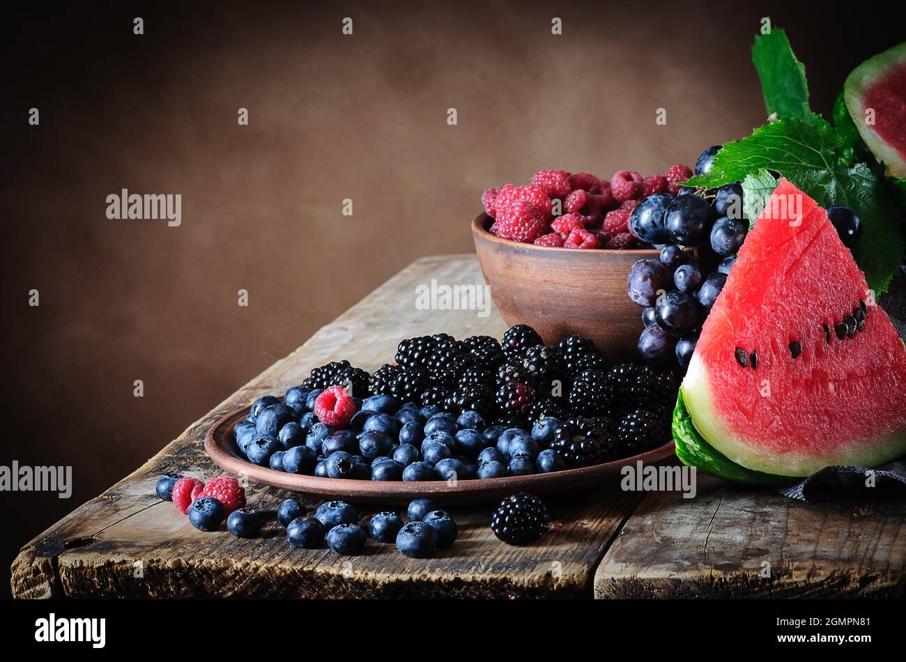 Ripe raspberries, blackberries, blueberries, grapes, watermelon on a ...