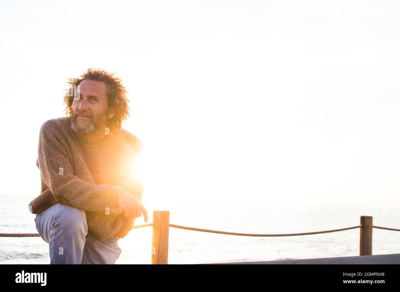 relaxed middle-aged man middle-aged man riding a boat Backlit by ...