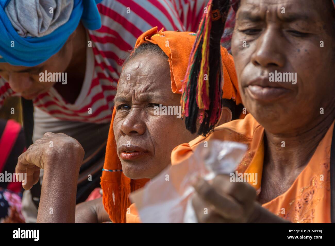 Faces of Tetum women,selling food on the weekly market of Oinlasi ...