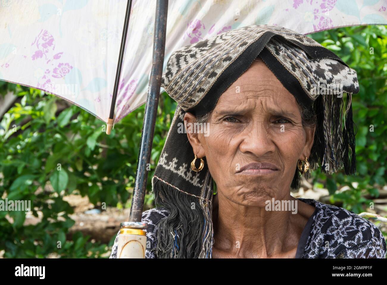 Portrait of a Tetum woman with an ikat headscarf in Oinlasi vilage ...