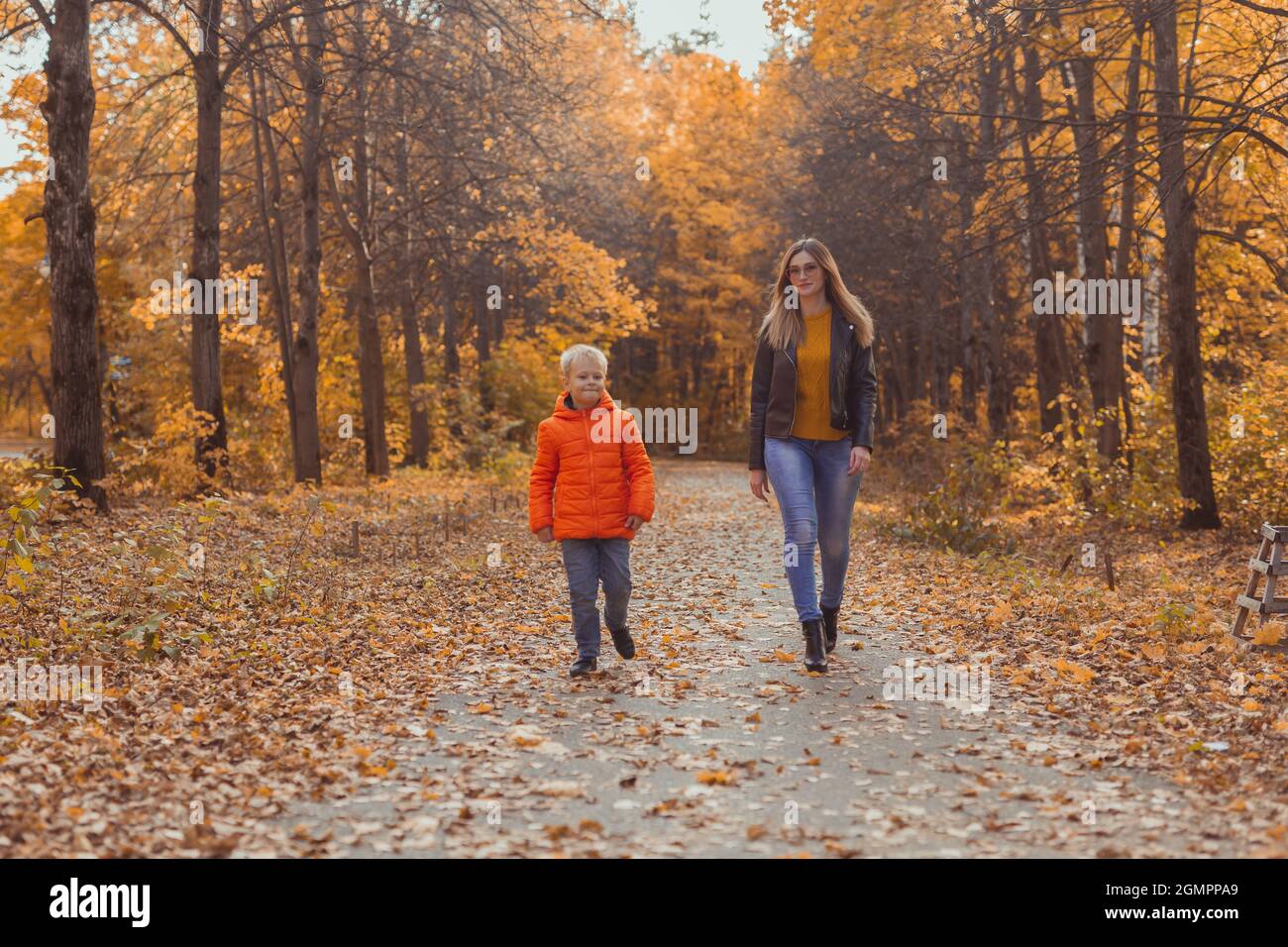 Mother and son walking in the fall park and enjoying the beautiful ...