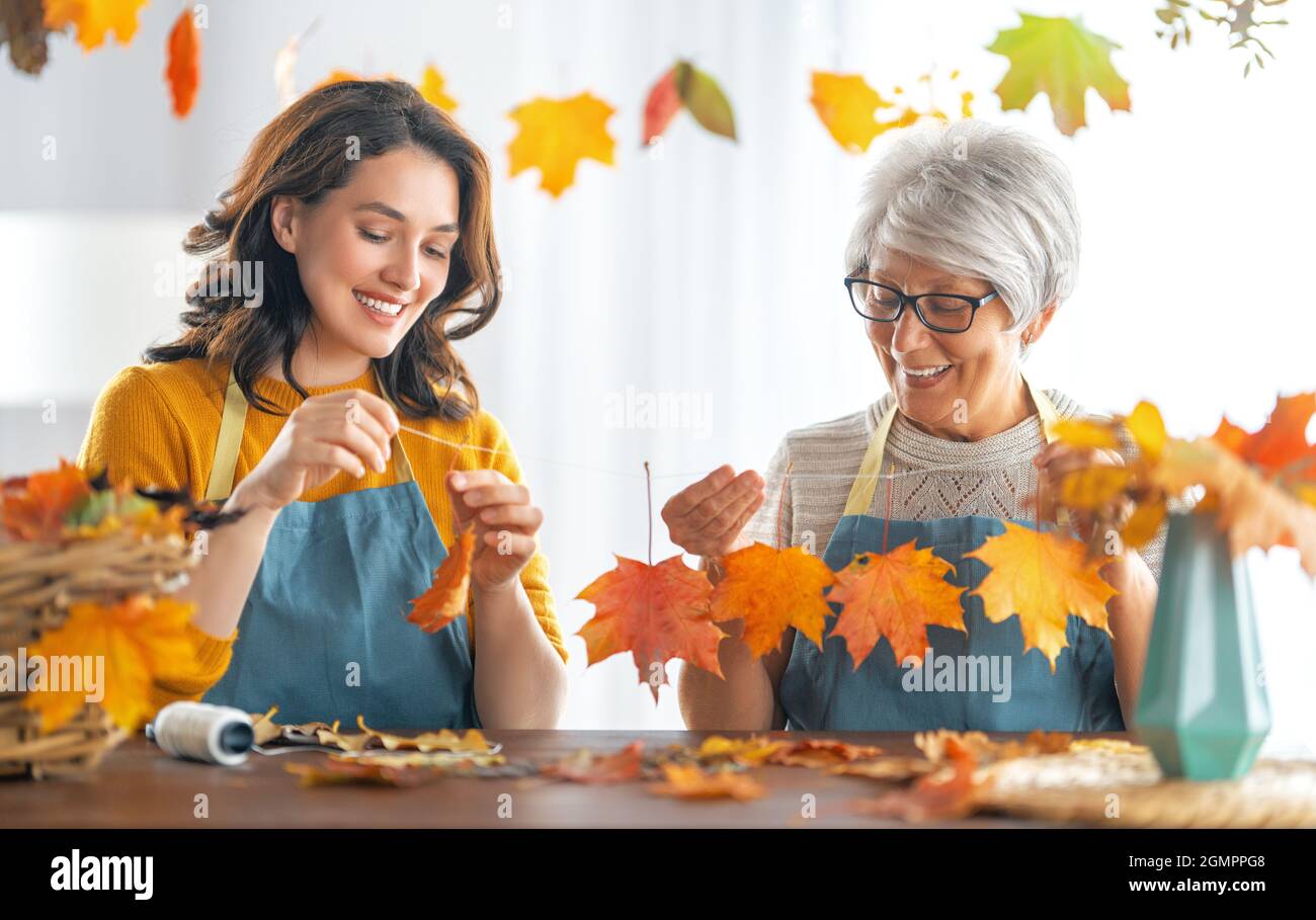 Happy family doing autumn decor. Fall atmosphere Stock Photo - Alamy