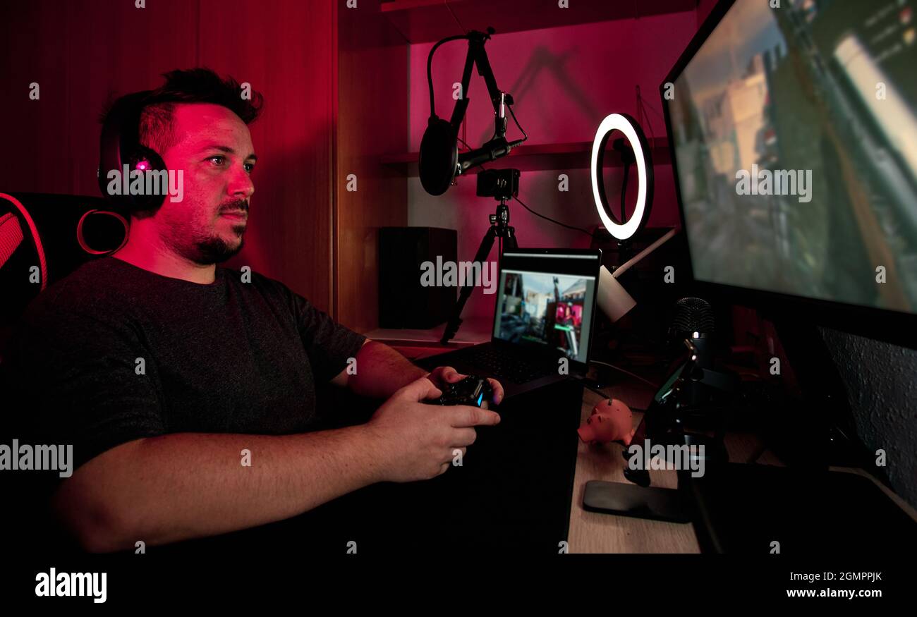 a gamer playing and streaming live with microphones and cameras Stock ...