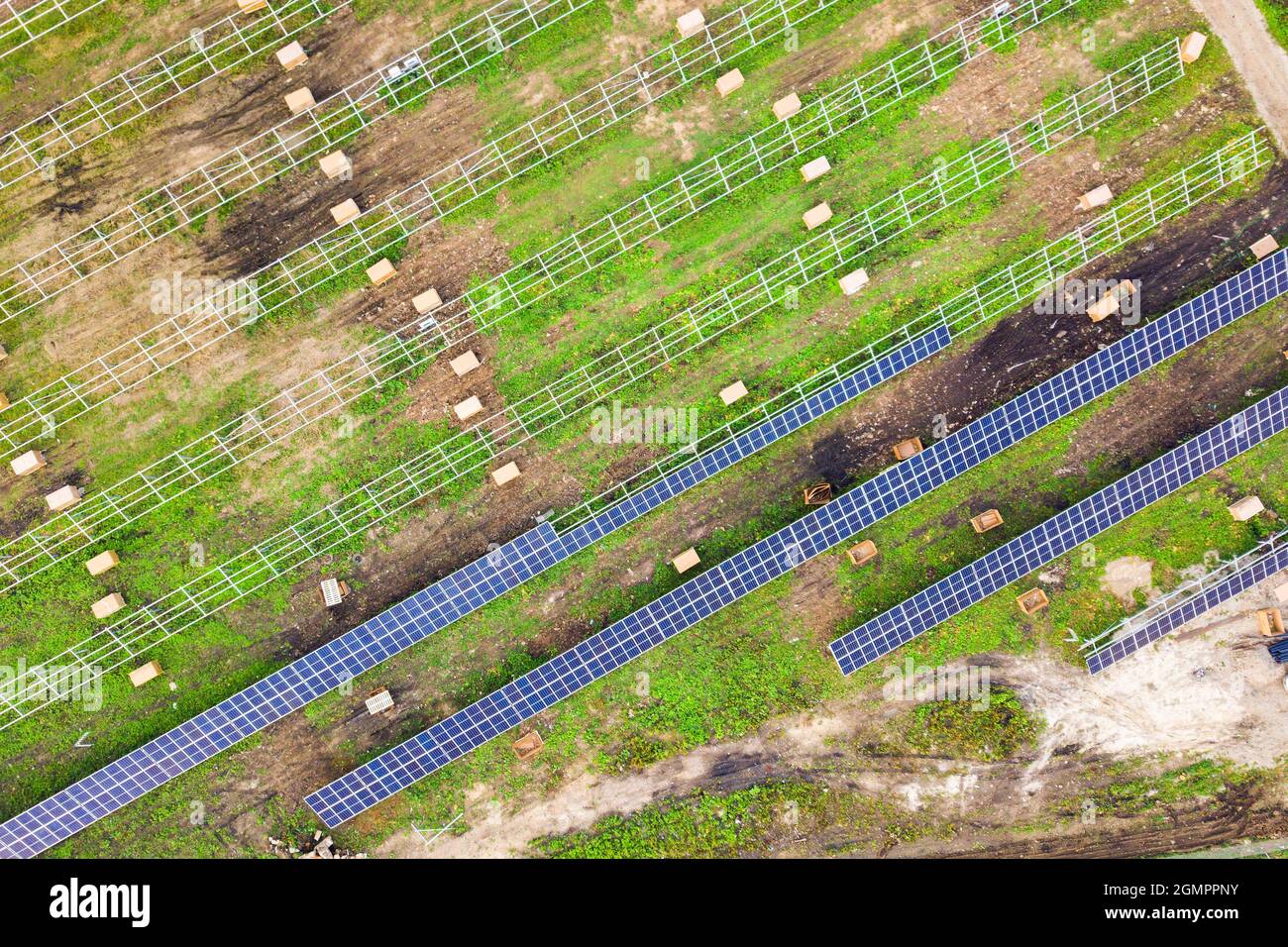 Aerial view of solar power plant under construction on green field ...