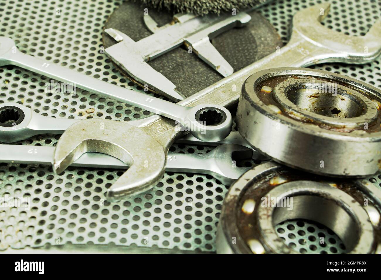 Metalworking tools, steel parts, a wrench, on the background of a metal ...