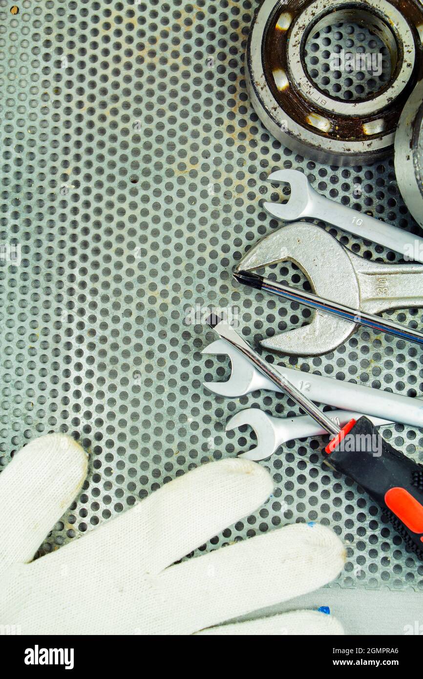 Metalworking tools, steel parts, a wrench, on the background of a metal ...