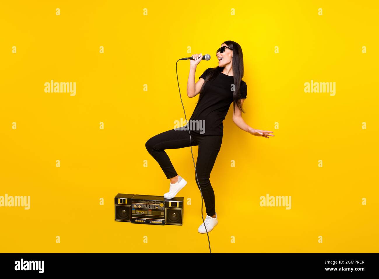 Full body portrait of carefree positive person hold mic put leg on ...