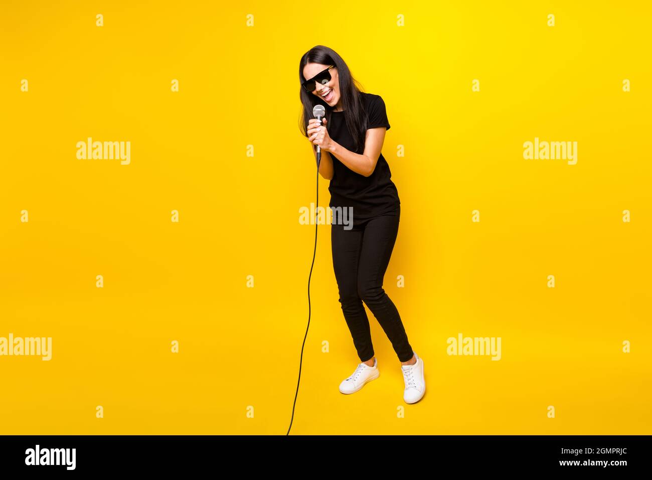 Full size portrait of carefree lady hands hold mic open mouth singing ...