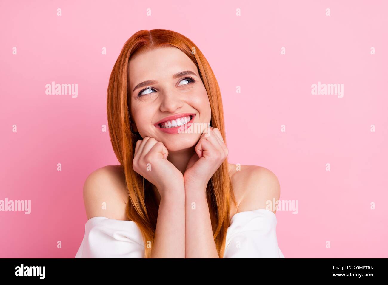 Portrait of attractive girlish dreamy cheerful red-haired girl making ...