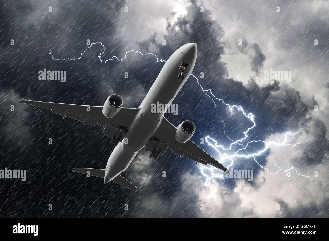 White passenger airplane landing during a thunderstorm of rain, bad ...