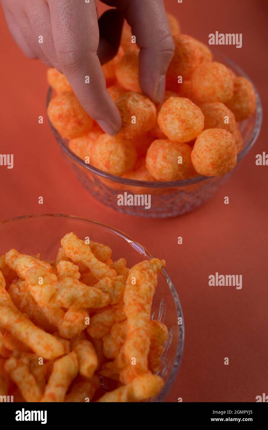 Orange cheese snacks in glass pots on an orange surface Stock Photo - Alamy