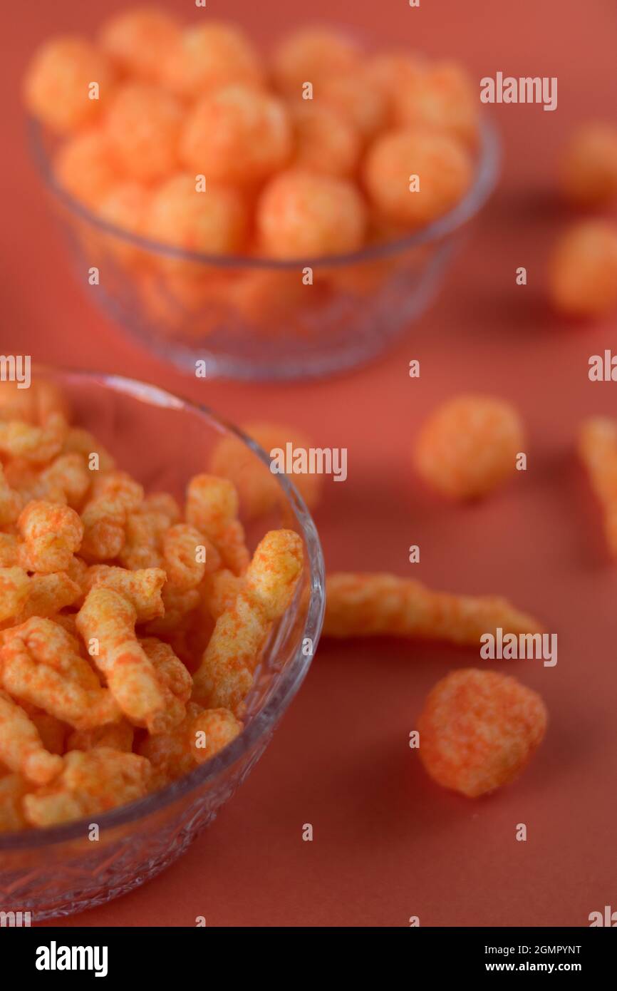 Orange cheese snacks in glass pots on an orange surface Stock Photo - Alamy