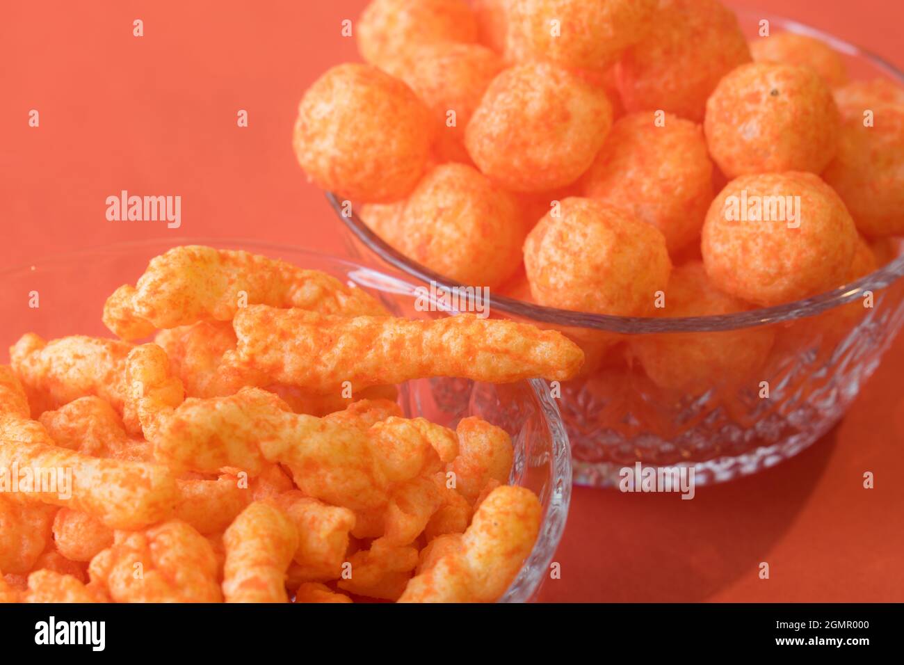 Orange cheese snacks in glass pots on an orange surface Stock Photo - Alamy