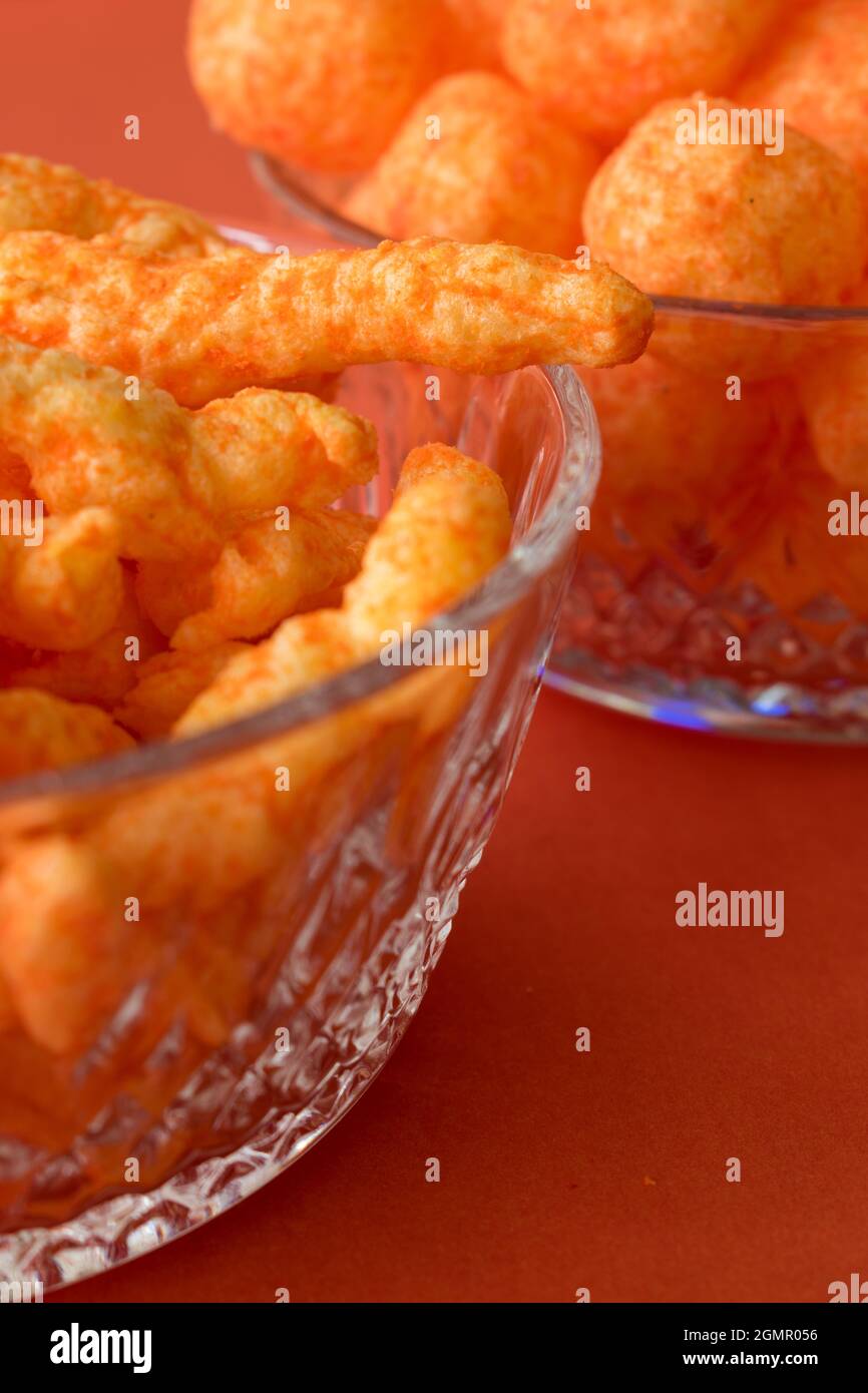 Orange cheese snacks in glass pots on an orange surface Stock Photo - Alamy