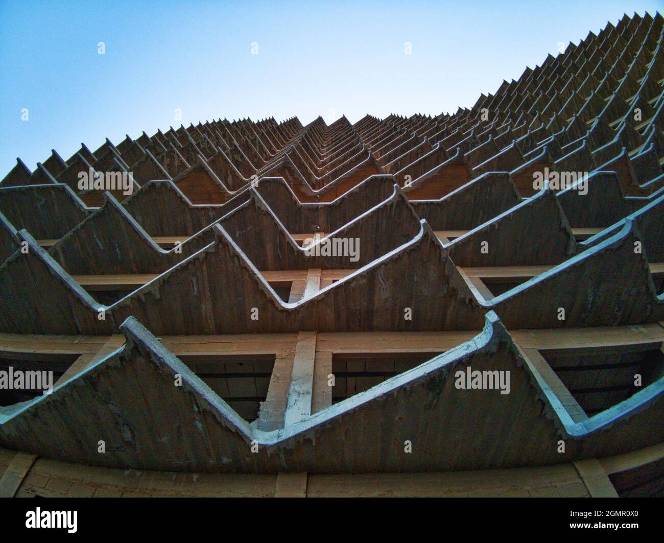 Exterior view of a half-constructed building on a clear sky background ...