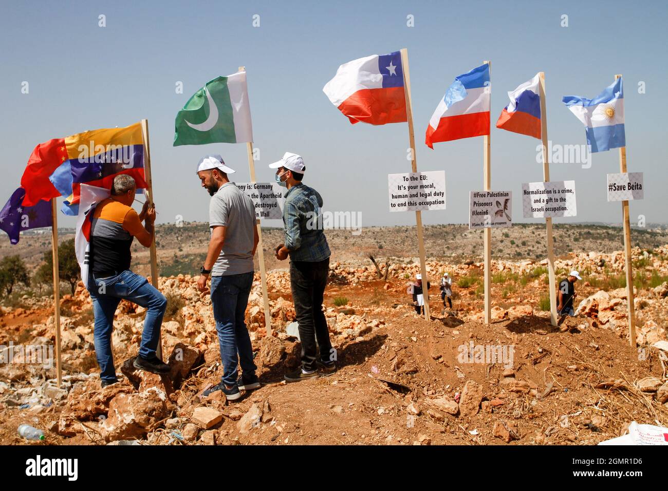 Palestinian protesters are seen setting up flags of countries that ...