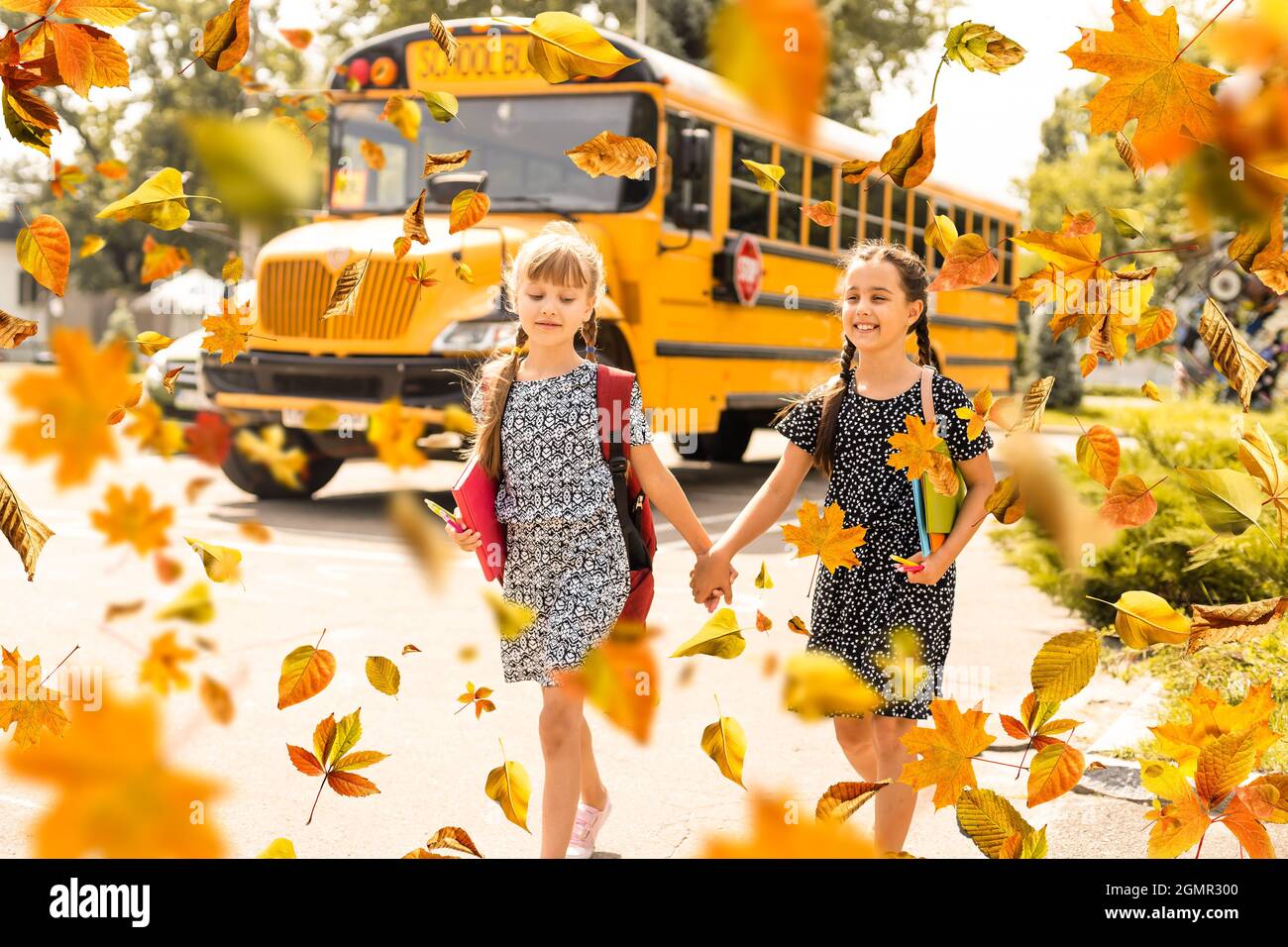 Happy Caucasian children elementary student running by yellow bus on ...