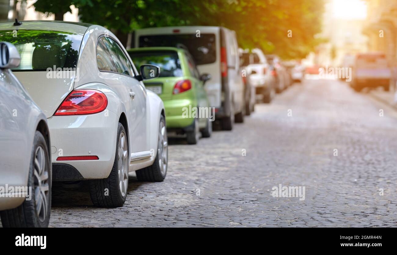 City traffic with cars parked in line on street side Stock Photo - Alamy