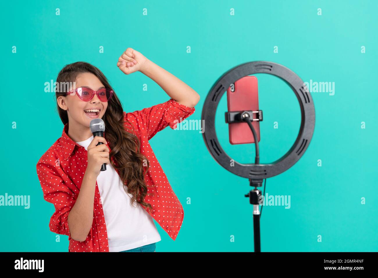 happy teen girl singer blogging online with selfie led and microphone ...