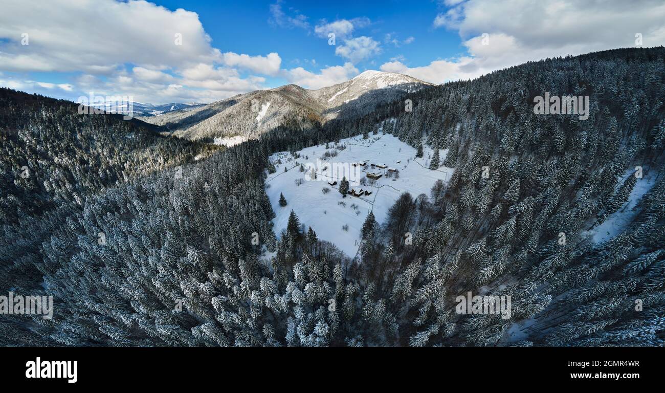 Aerial winter landscape with small rural houses between snow covered ...