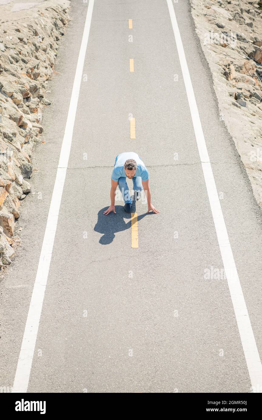 healthy lifestyle. mature man on road start. sport activity. full of ...
