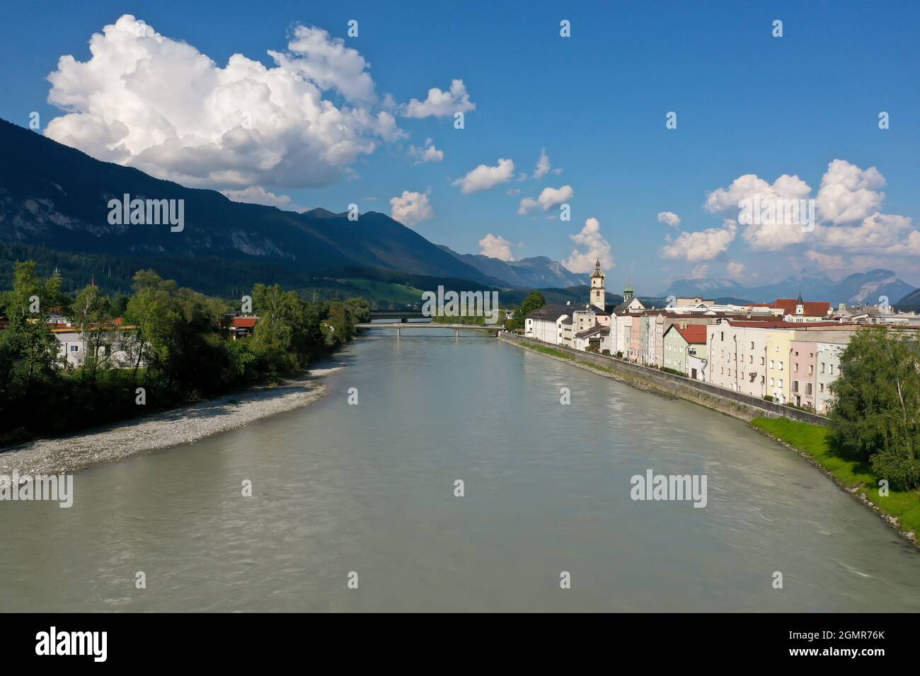 Landscape of a river surrounded by hills and greenery in Rattenberg ...